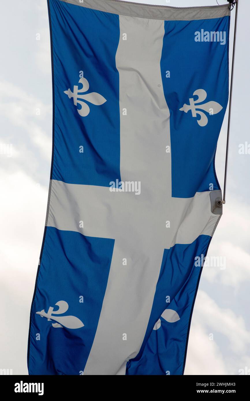 National flag of Quebec on a flagpole flutering on a wind Stock Photo ...