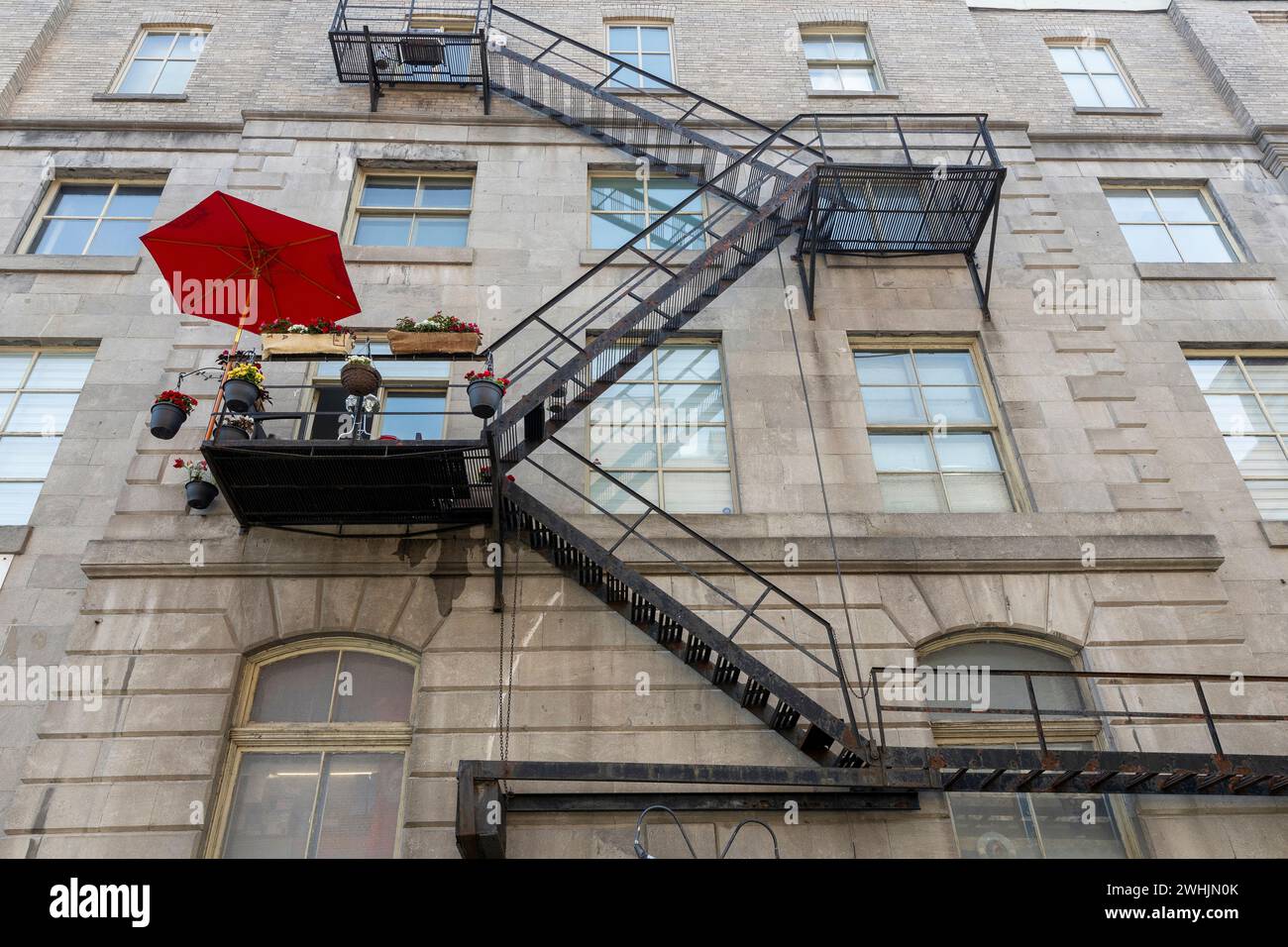 Facade of old buildings in downtown Montreal, Canada. Residential building with external fire ...