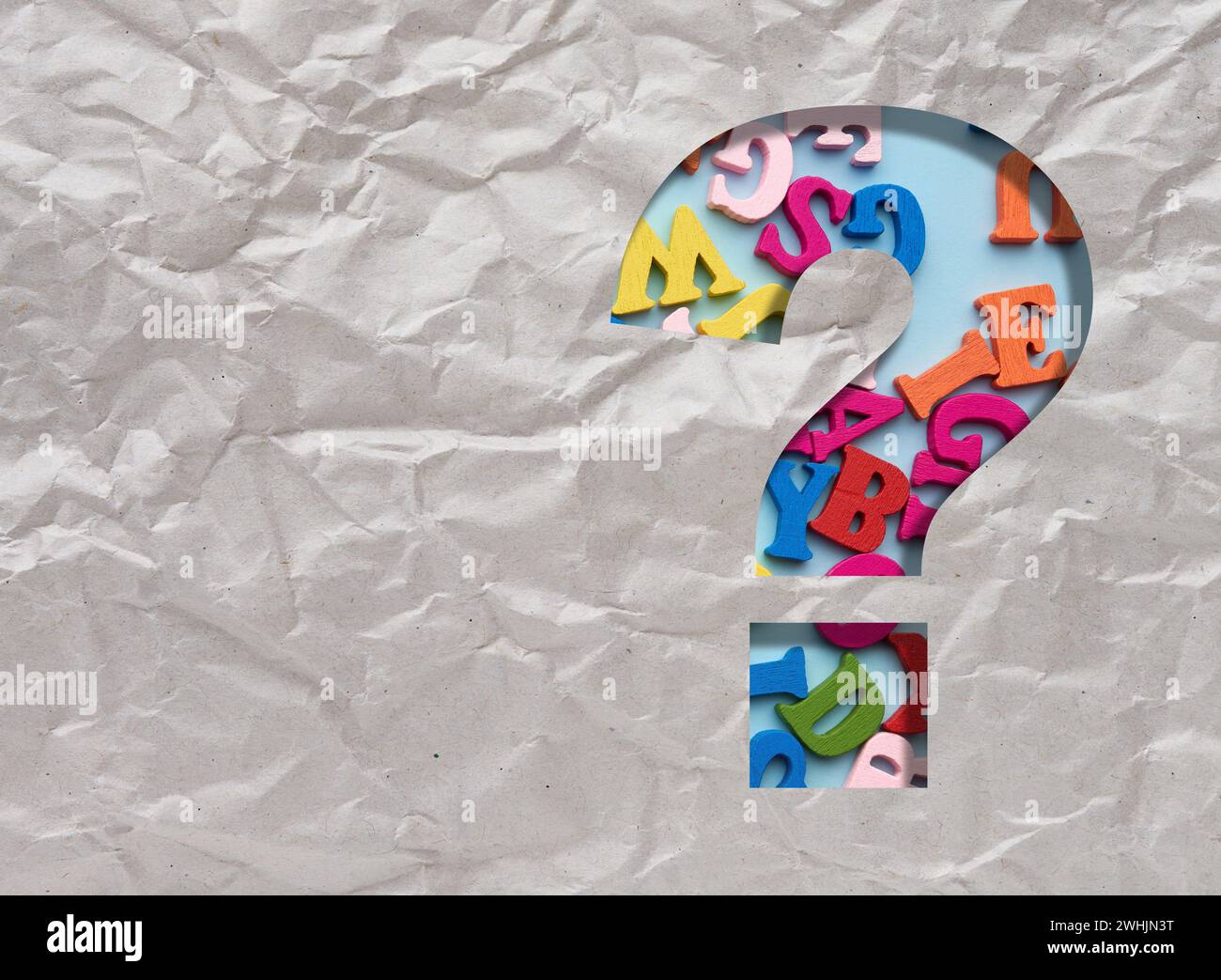 Question mark on crumpled gray paper, wooden letters inside Stock Photo ...