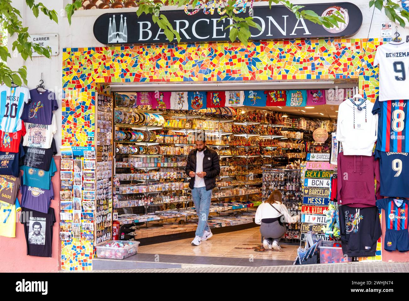 Traditional souvenir shop in Barcelona, Spain with tourists looking for ...