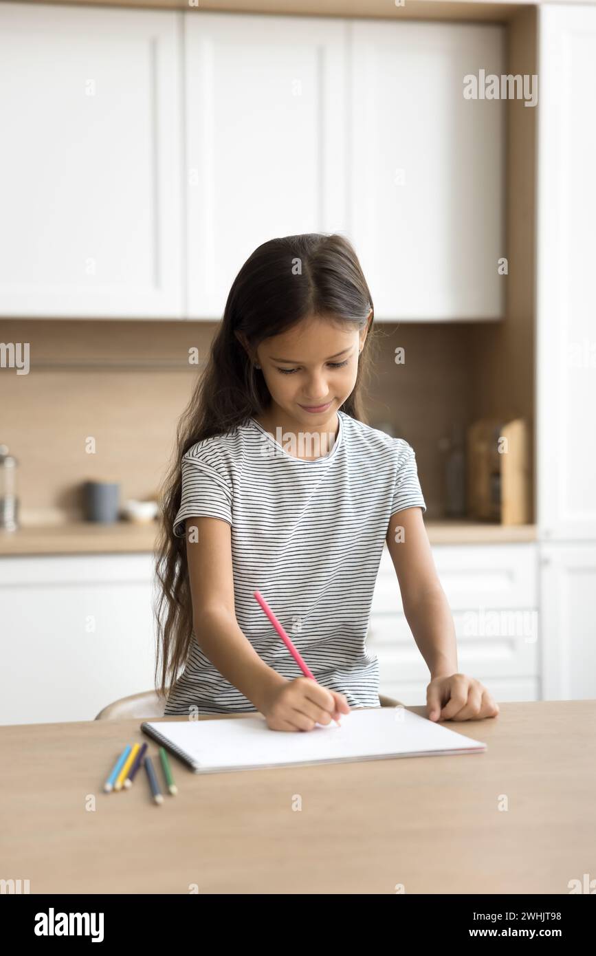Positive pretty little kid girl drawing in colored pencils Stock Photo ...