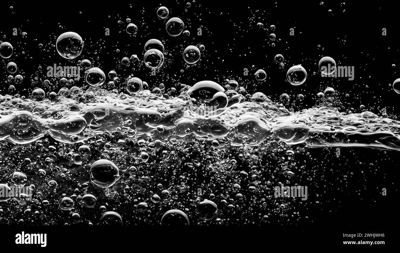 Soda water bubbles splashing underwater against black background. Soda liquid texture that ...