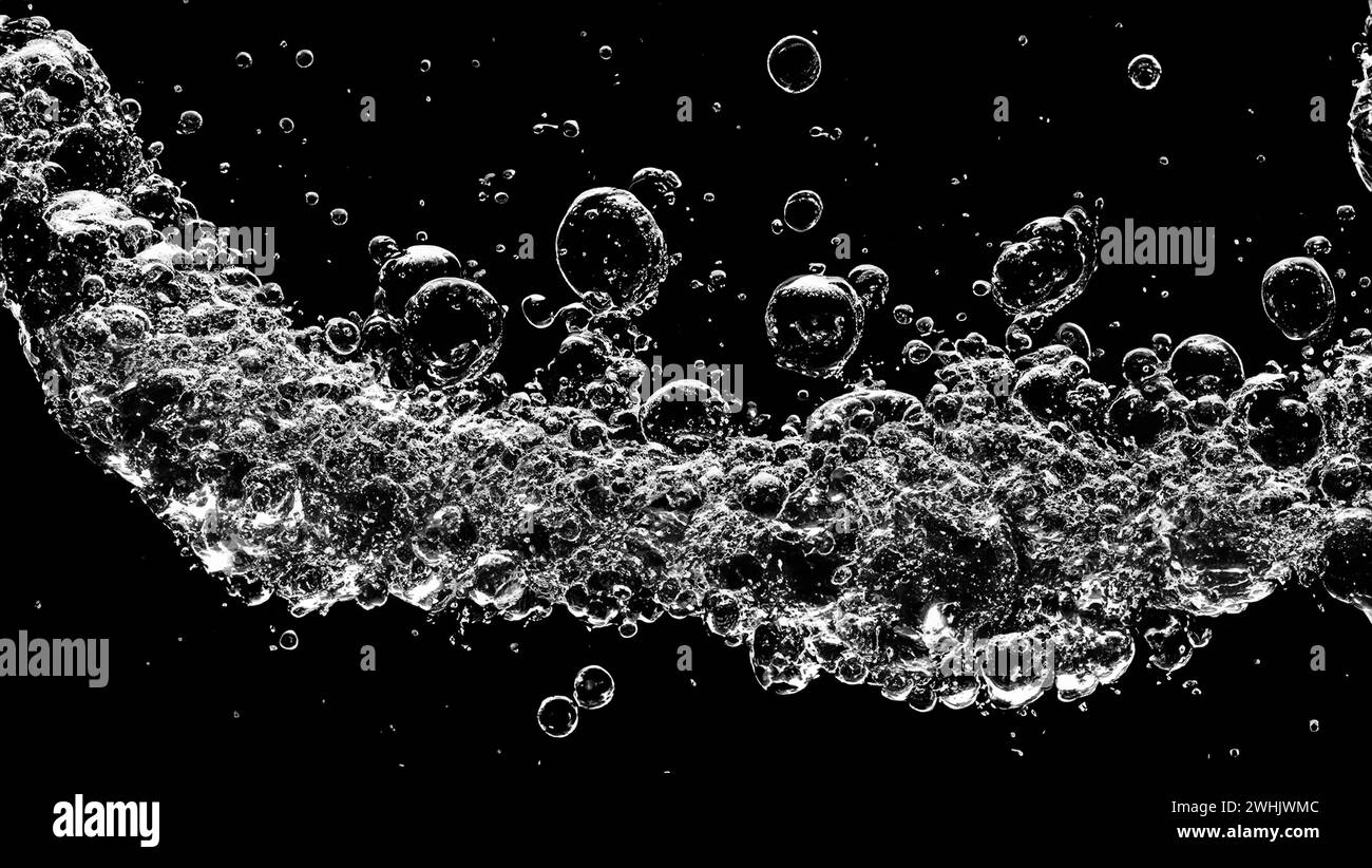 Soda water bubbles splashing underwater against black background. Soda liquid texture that ...
