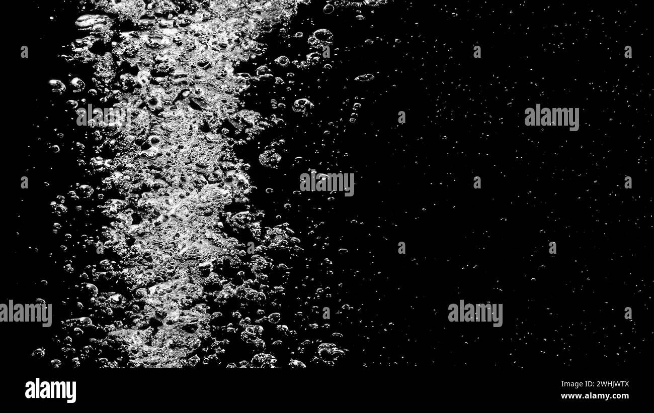 Soda water bubbles splashing underwater against black background. Soda liquid texture that ...