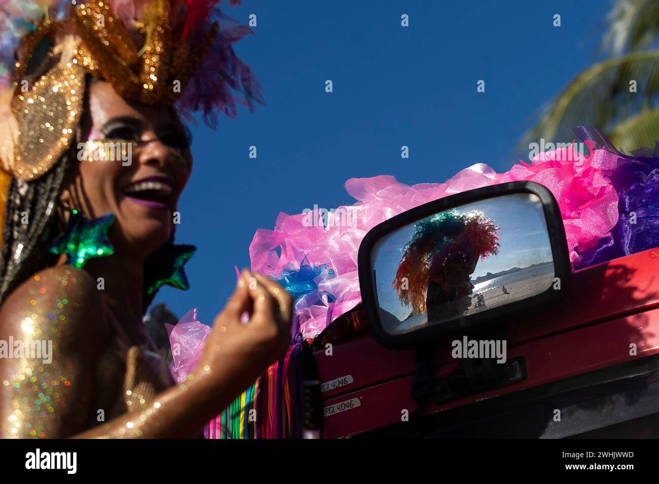 Stilt walker Raquel Poti is reflected in a mirror as she prepares to ...