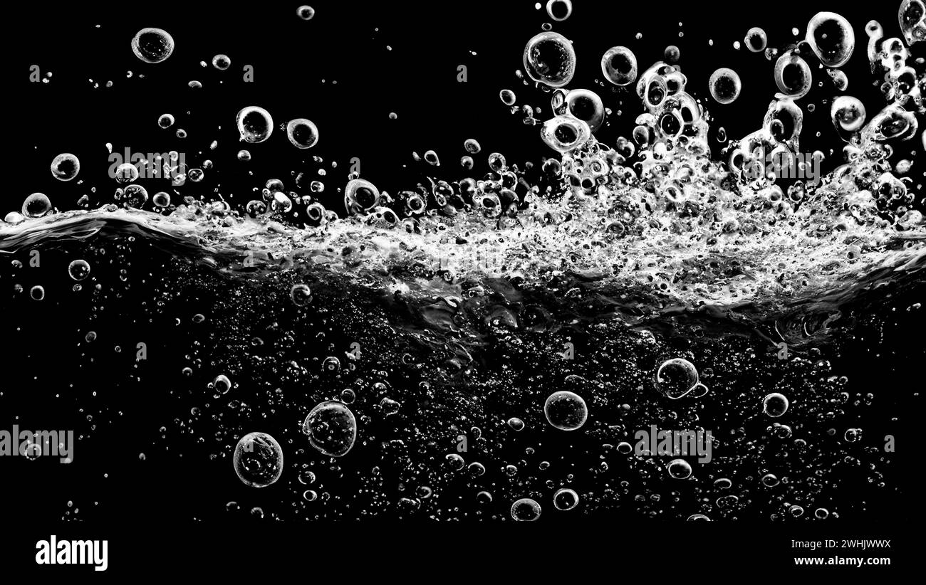 Soda water bubbles splashing underwater against black background. Soda liquid texture that ...
