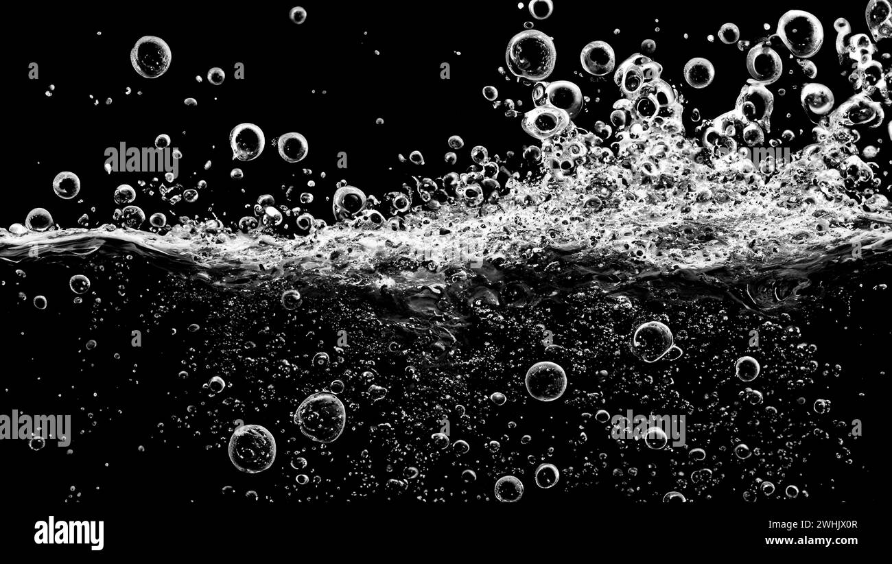 Soda water bubbles splashing underwater against black background. Soda liquid texture that ...