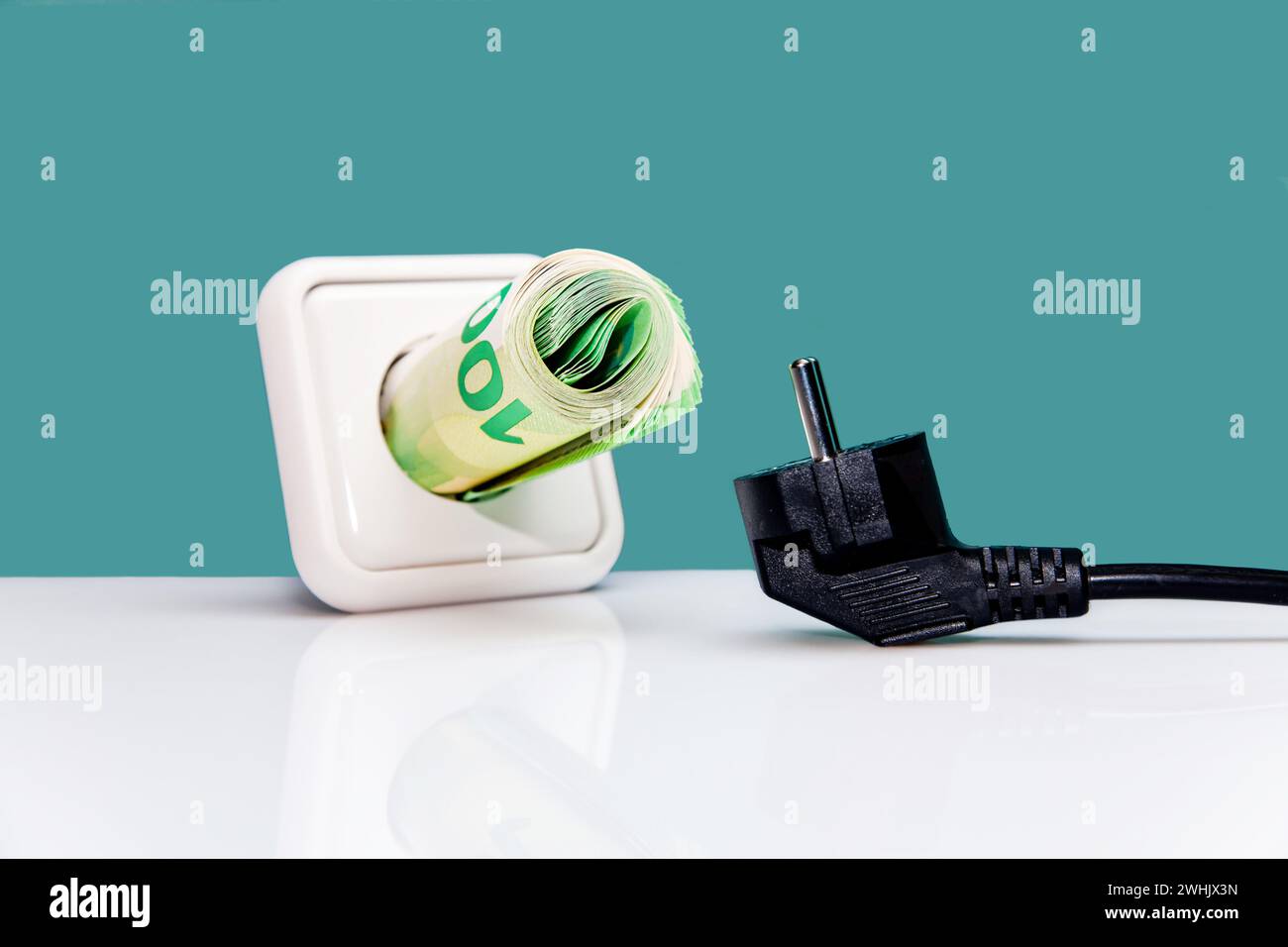 Euro banknotes plugged into the Black European plug socket on green ...