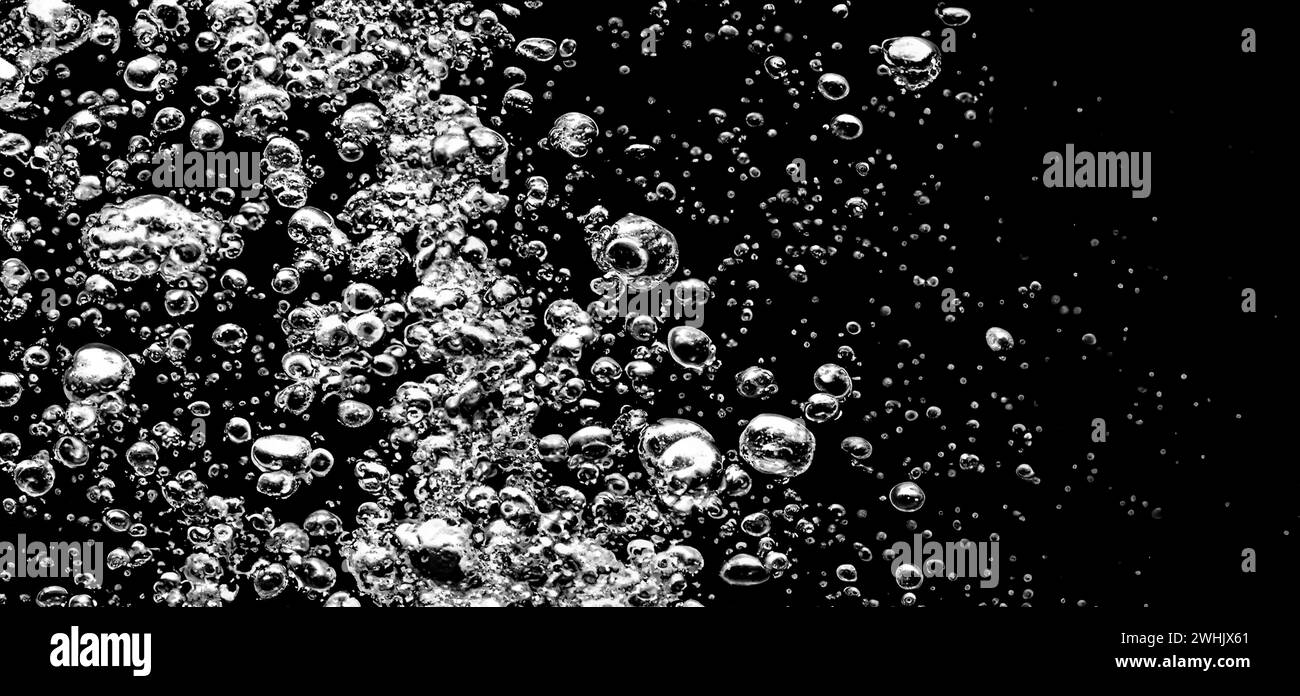 Soda water bubbles splashing underwater against black background. Soda liquid texture that ...