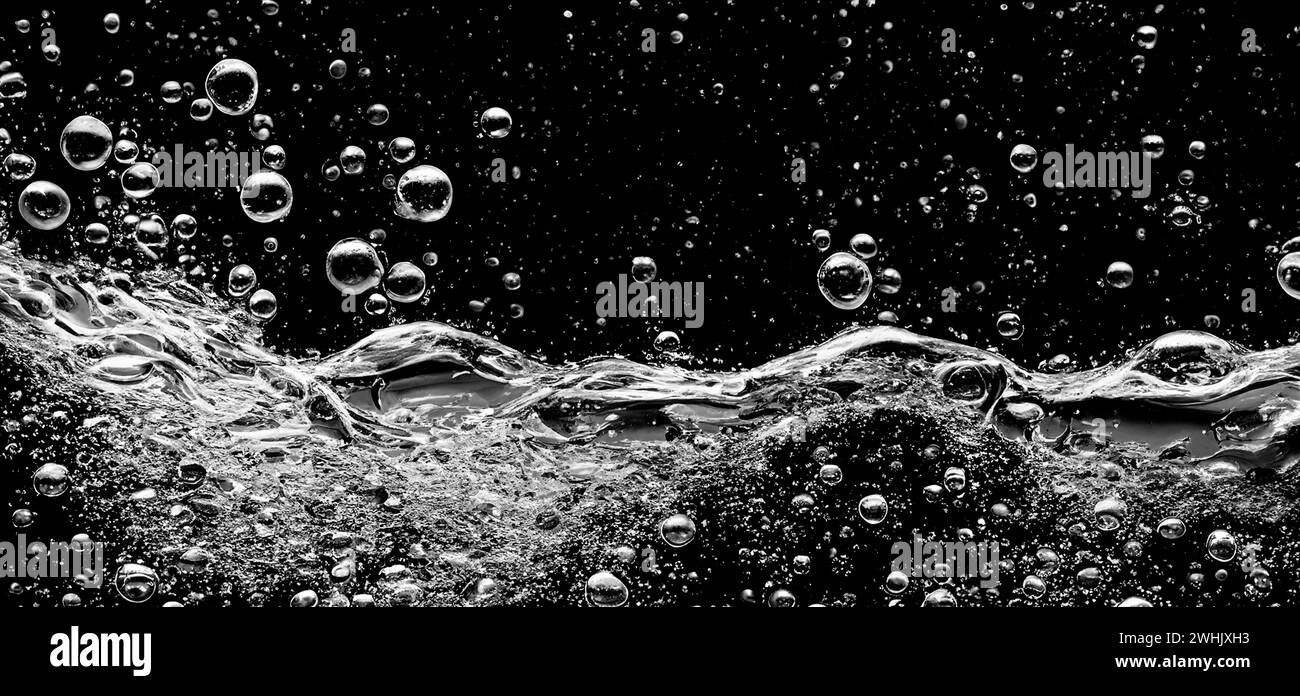 Soda water bubbles splashing underwater against black background. Soda ...