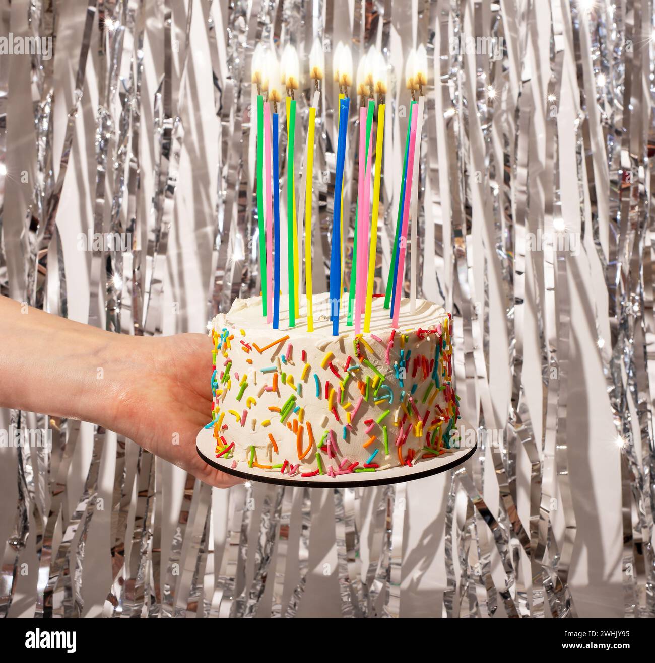Birthday bento cake with high tall candles in hand Stock Photo - Alamy