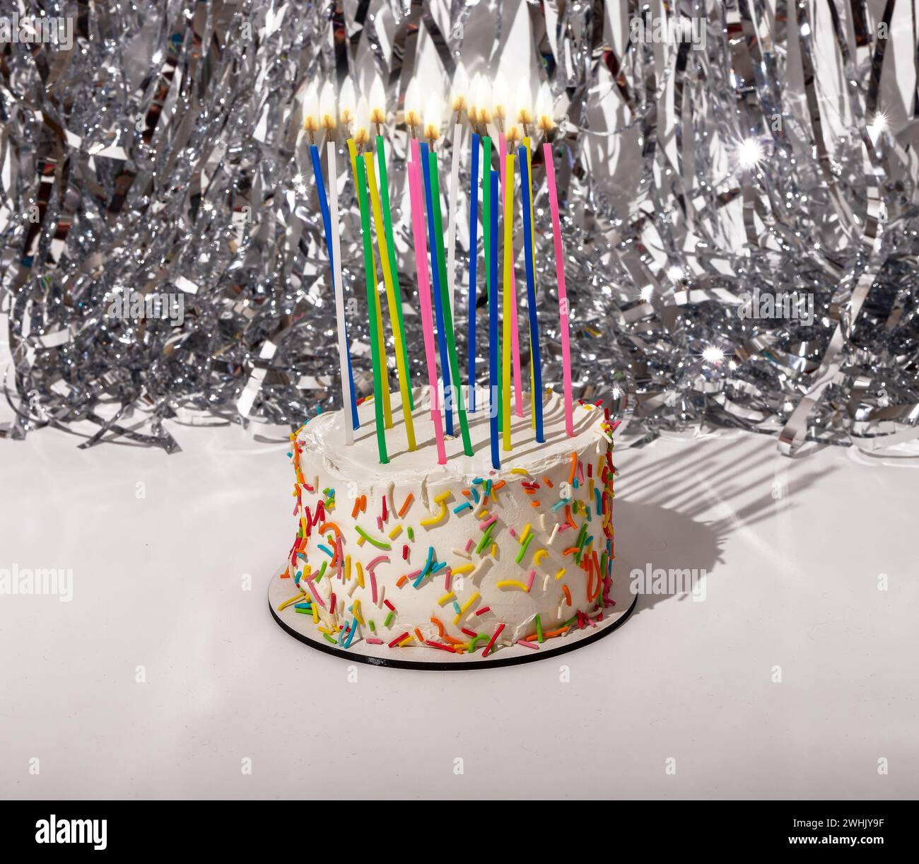 Birthday bento cake with high tall candles, shiny tinsel Stock Photo ...