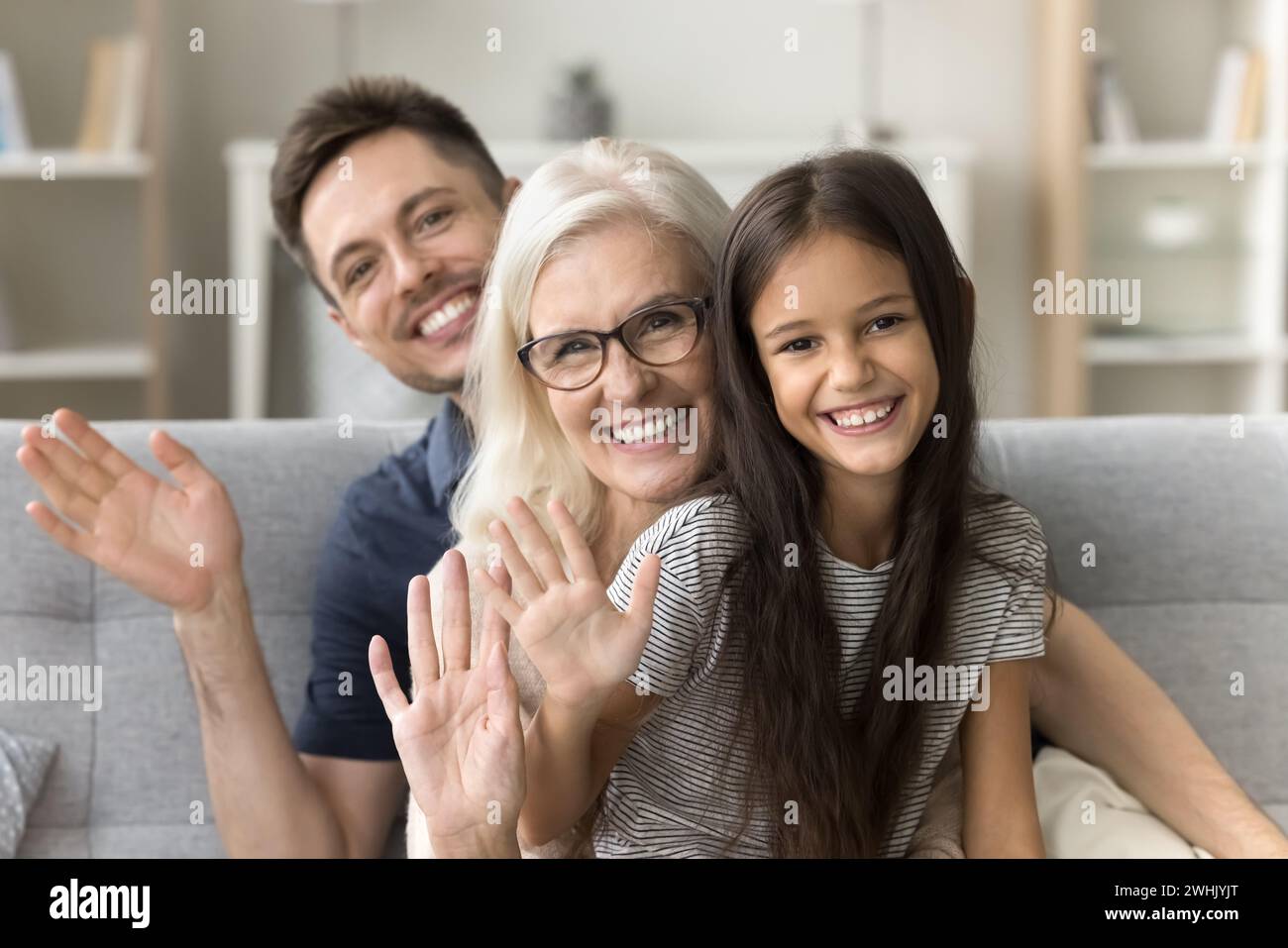 Cheerful kid girl, grandma and handsome dad looking at camera Stock ...