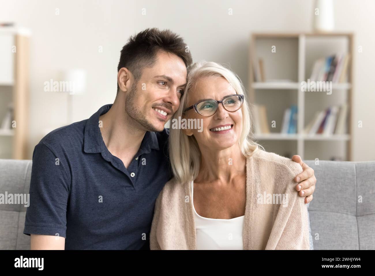 Happy thoughtful adult child man hugging senior mom with love Stock ...