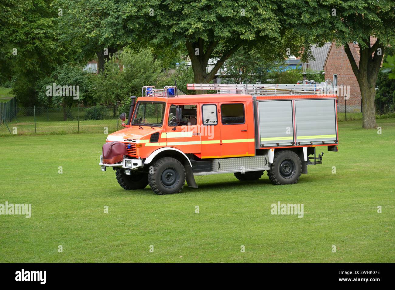 German fire engine, red orange truck with ladders on the roof and ...