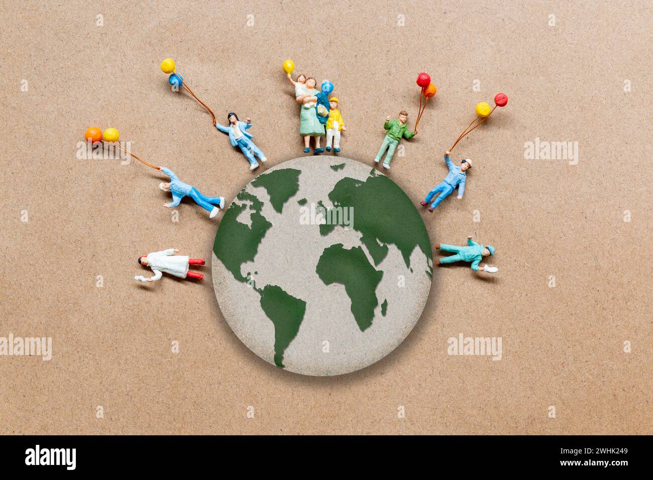 Miniature people standing on the globe with paper background Stock ...