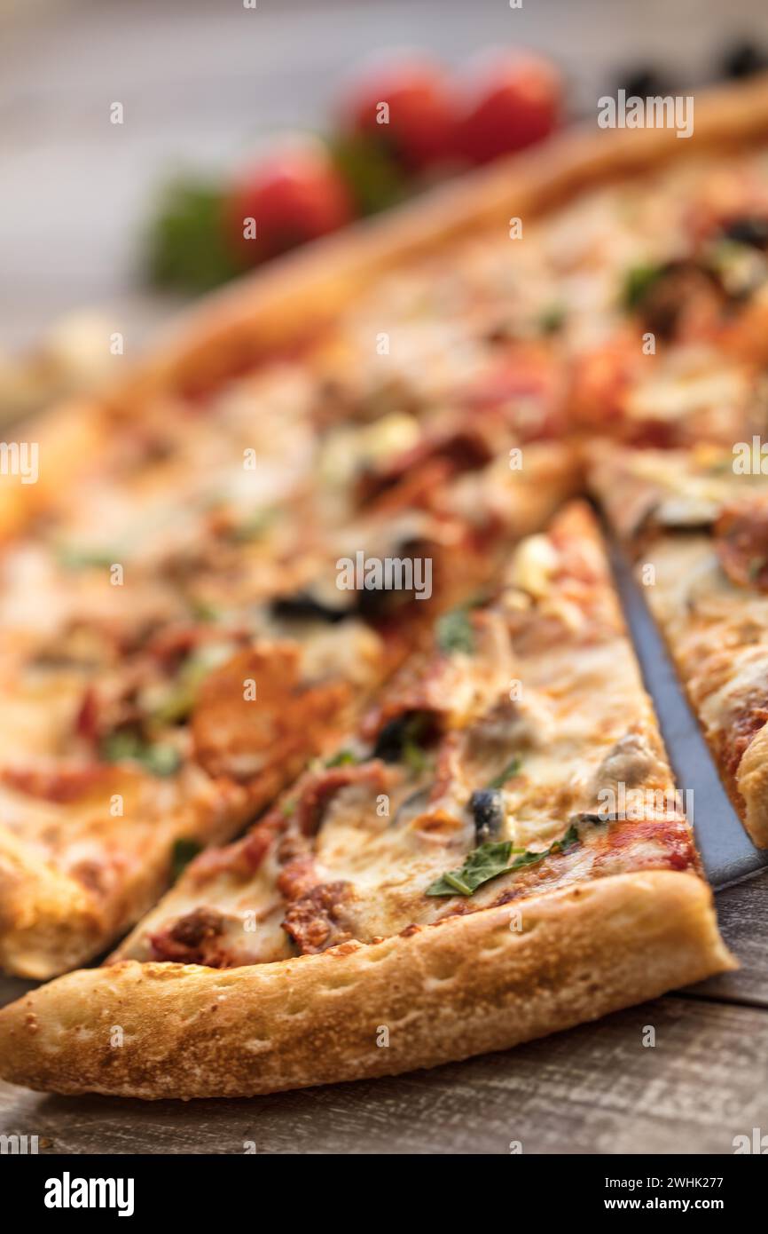 Pizza on an old wooden table Stock Photo - Alamy
