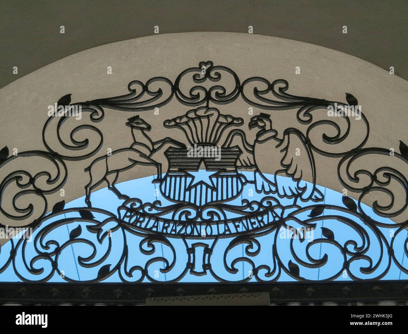 detail of entrance gate where it is written in Spanish "por la razon o ...