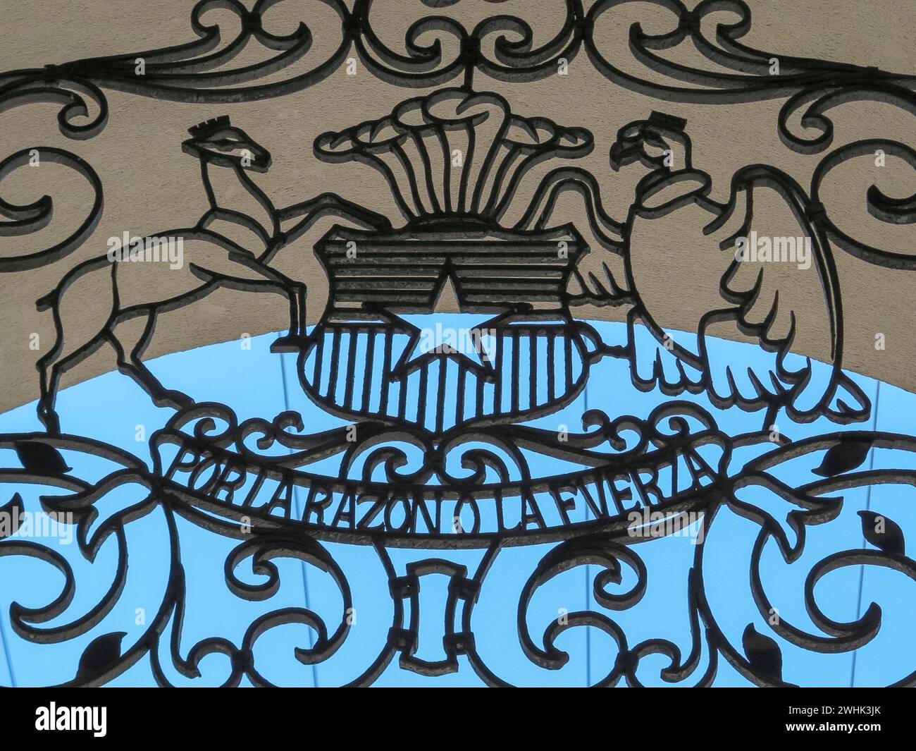 detail of entrance gate where it is written in Spanish "por la razon o ...