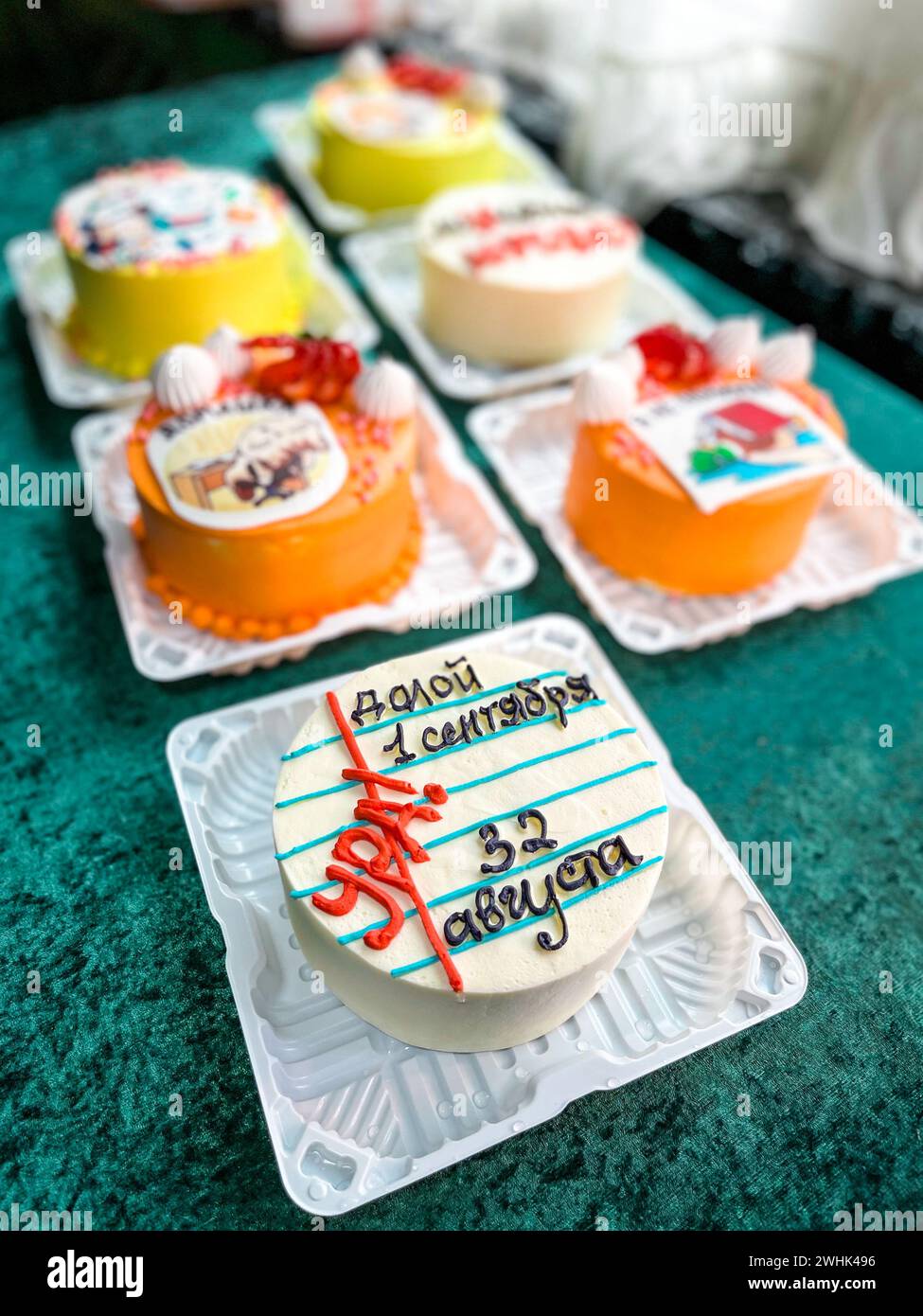 A round white cake with red and blue icing that says 1 September ...