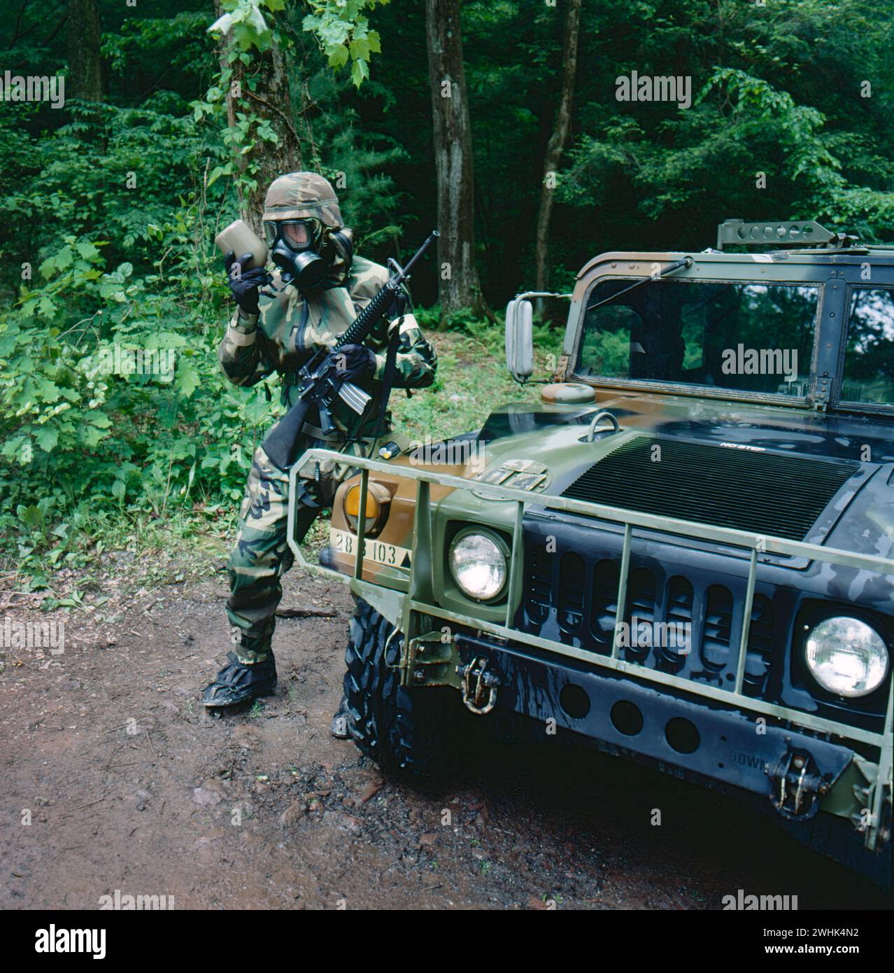 Soldier in training with automatic rifle; Humvee Jeep; U.S. Army ...