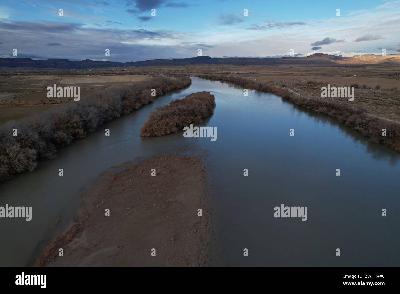 Water flows down the Green River, a tributary of the Colorado River ...