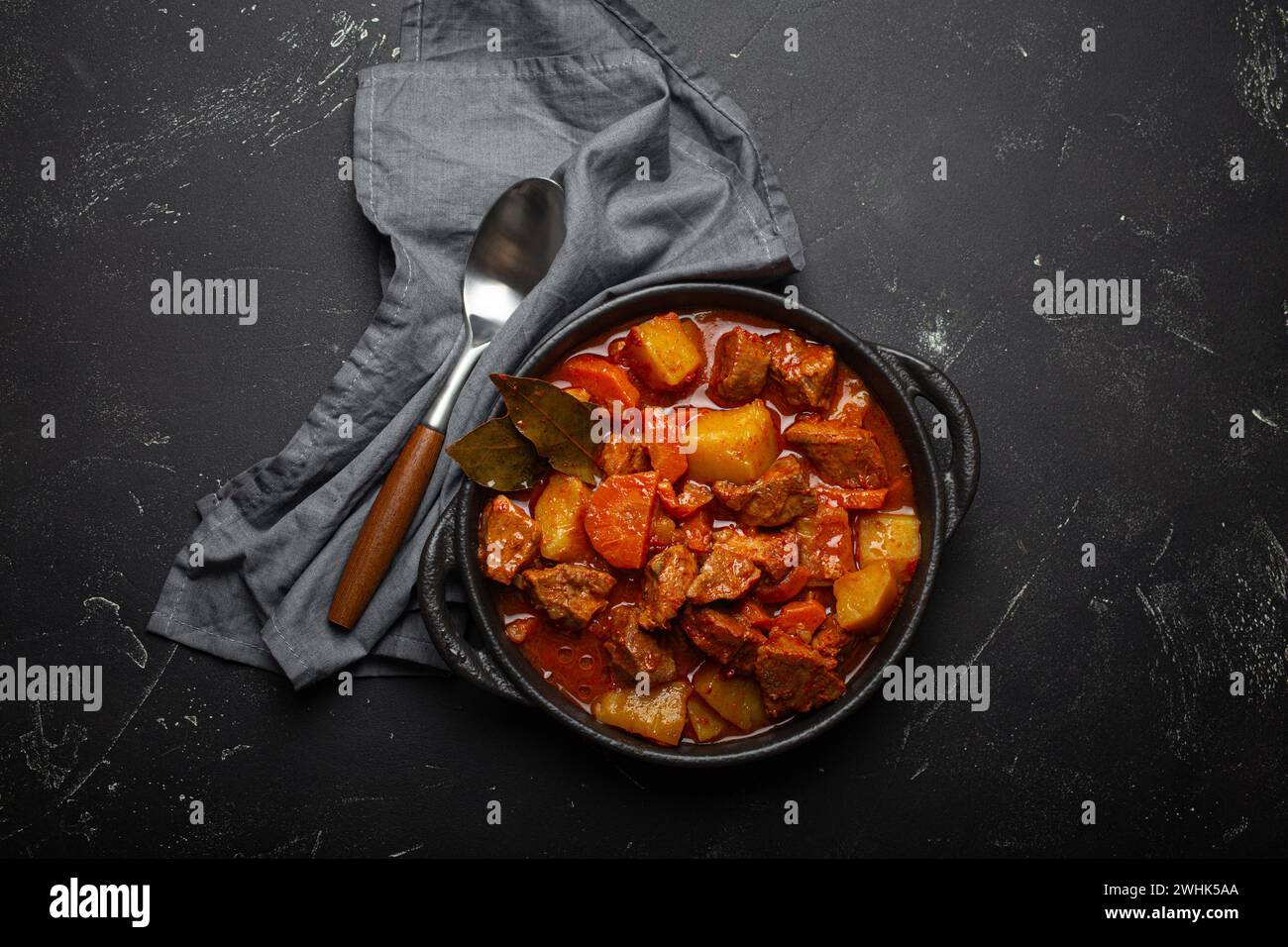 Beef meat stew with potatoes, carrot and delicious gravy in black ...