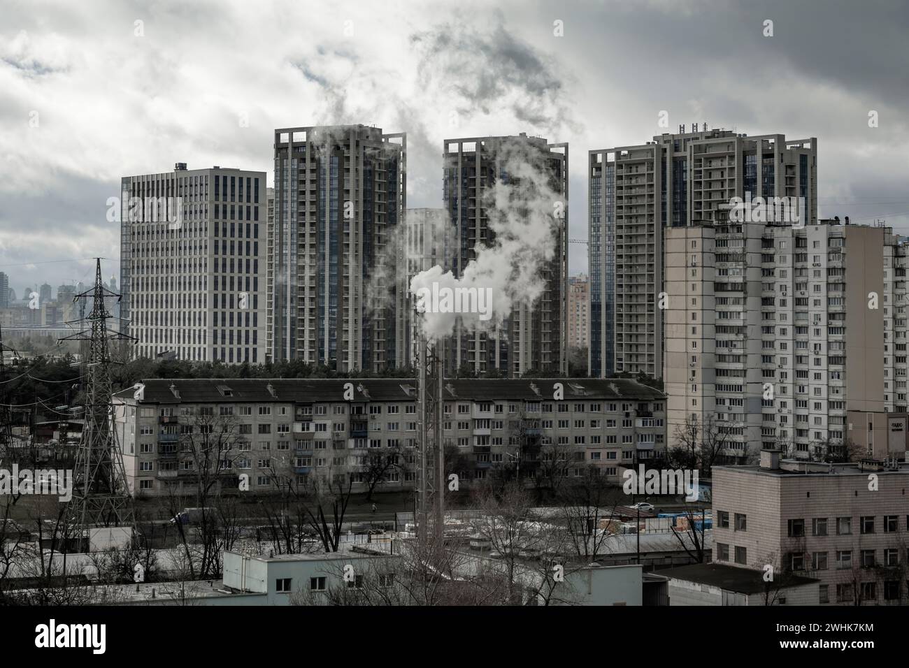 Dramatic urban environment in grey tones. Smoking chimneys, power line ...