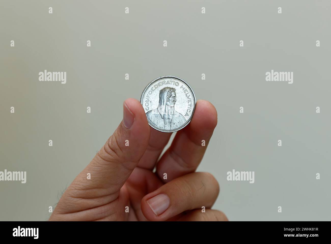 swiss five franc coin between fingers - swiss franc coin Stock Photo ...
