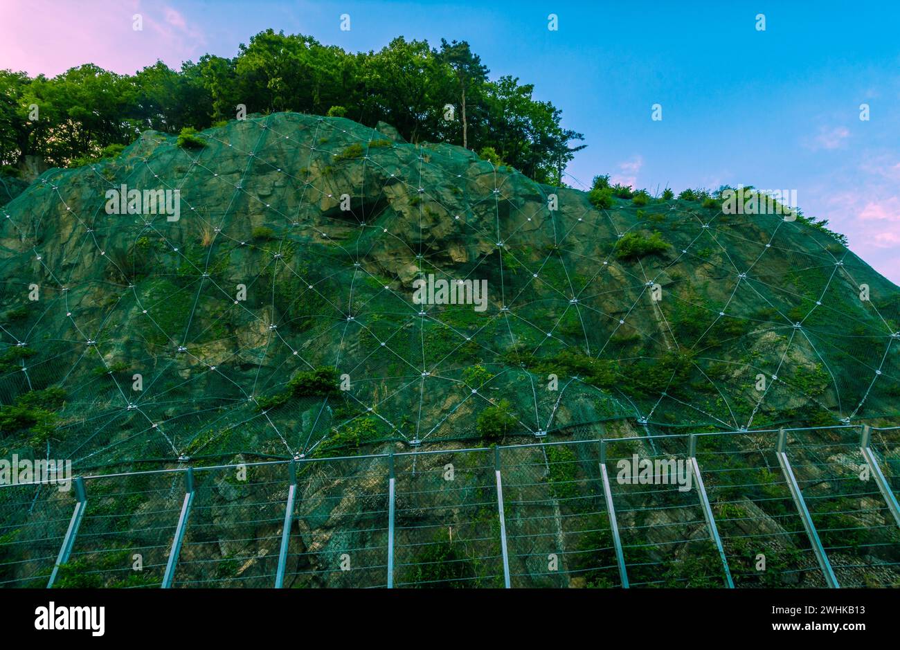 Large boulders on side of mountain secured with wire mesh netting ...