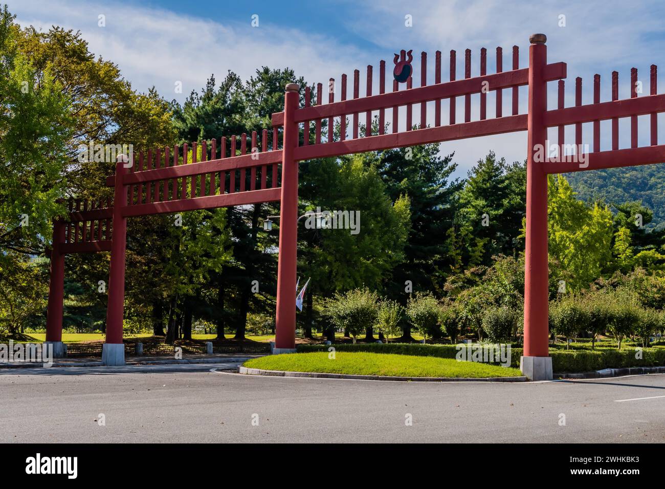 Large wooden Japanese style gate across four lane road in public park ...