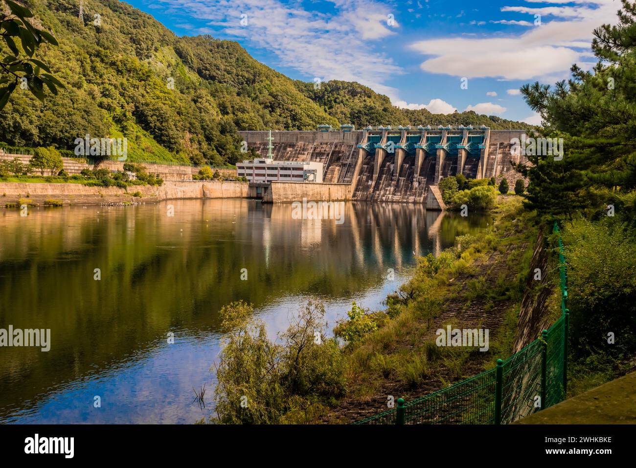 Beautiful landscape of dam on river under cloudy blue sky in mountain ...
