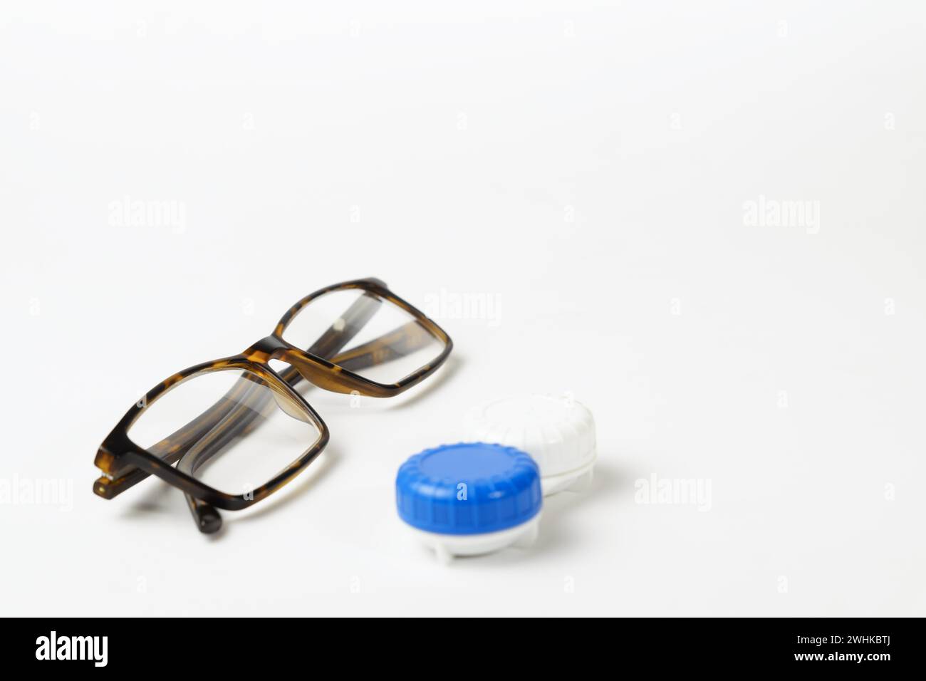Glasses and contact lenses on a white table isolated on a white ...