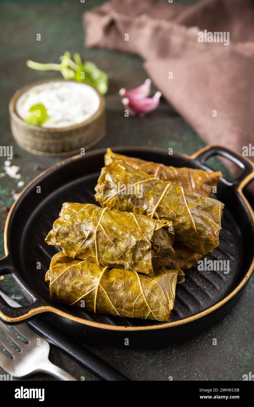 Delicious dolma - stuffed grape leaves with rice and meat on a dark ...