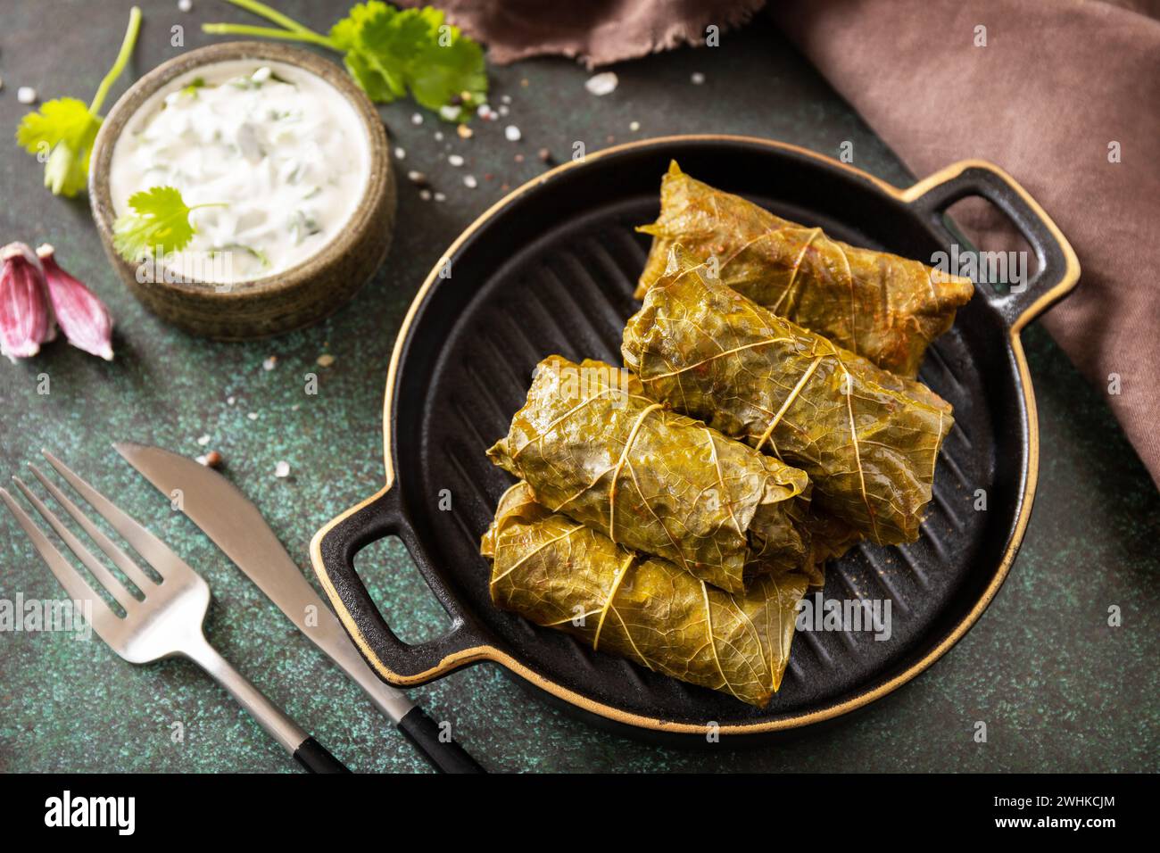 Delicious dolma - stuffed grape leaves with rice and meat on a dark ...