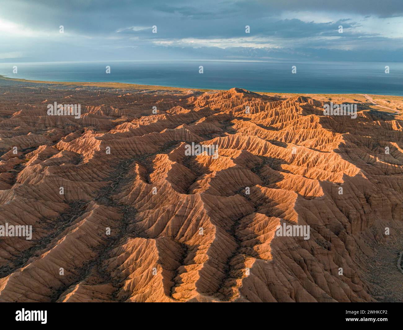 Landscape of eroded hills, badlands at sunset, Issyk Kul Lake in the ...