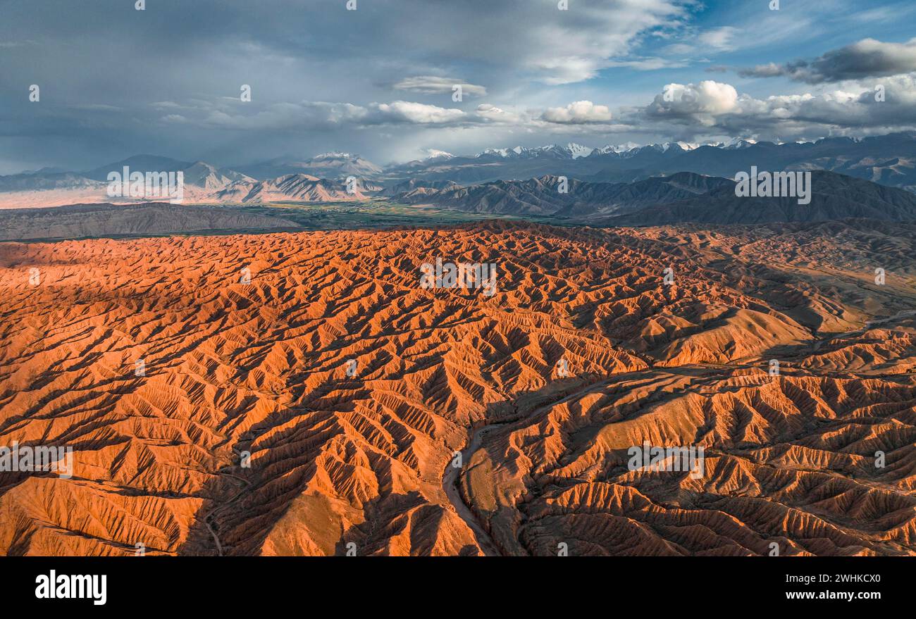 Landscape of eroded hills, badlands at sunset, mountain peaks of the ...