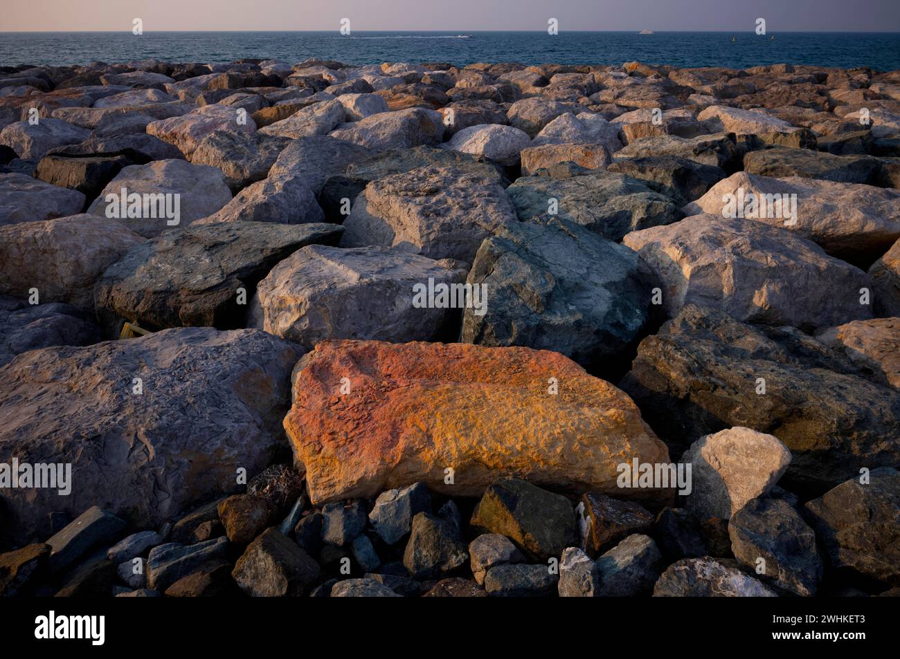 Stones, rocks that form the foundation for the artificial palm island ...