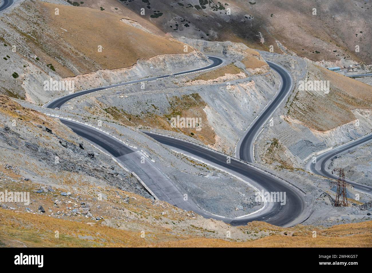 Winding roads on the Pamir Highway, mountain road through an eroded ...