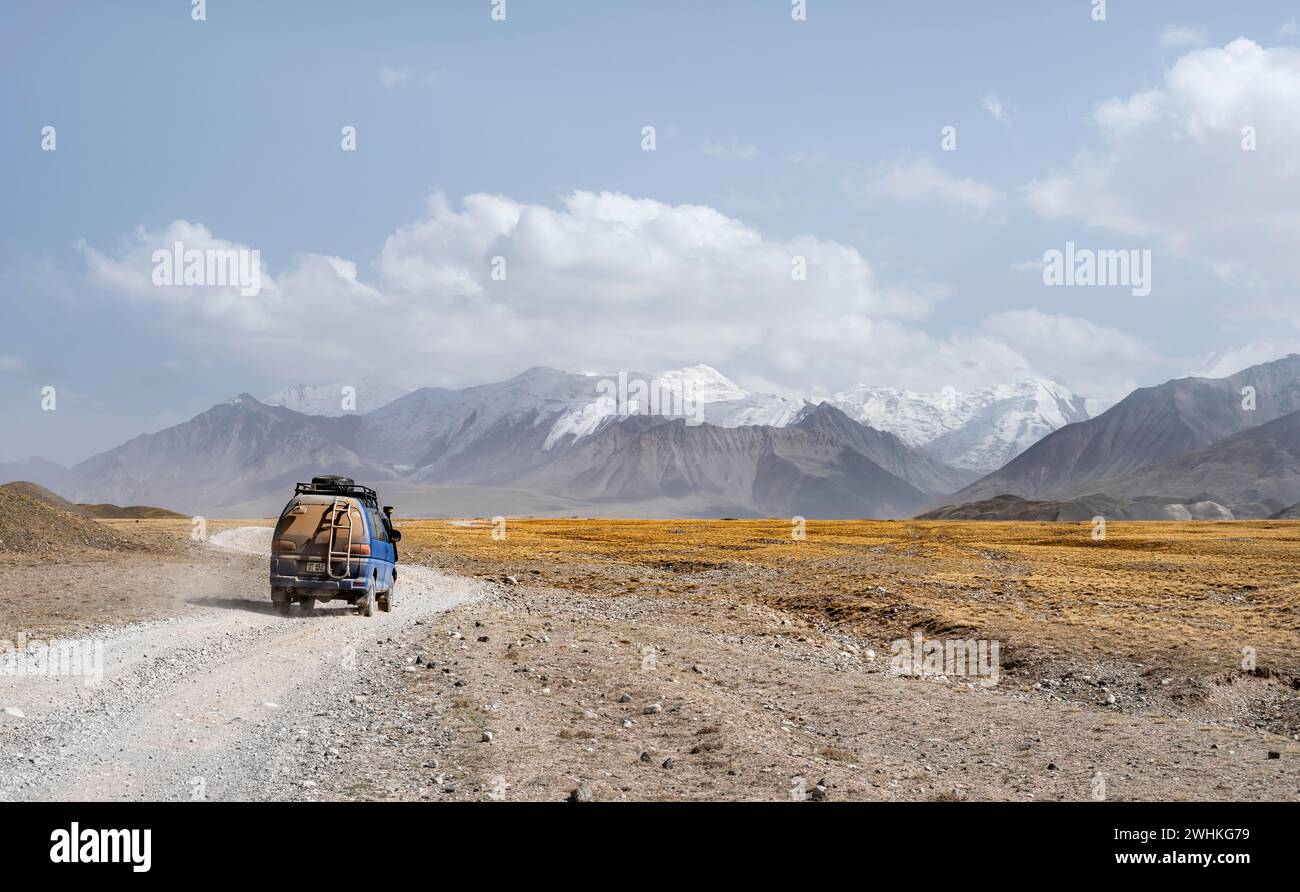 Nature tourism, road trip, overlander, off-road vehicle on a gravel ...