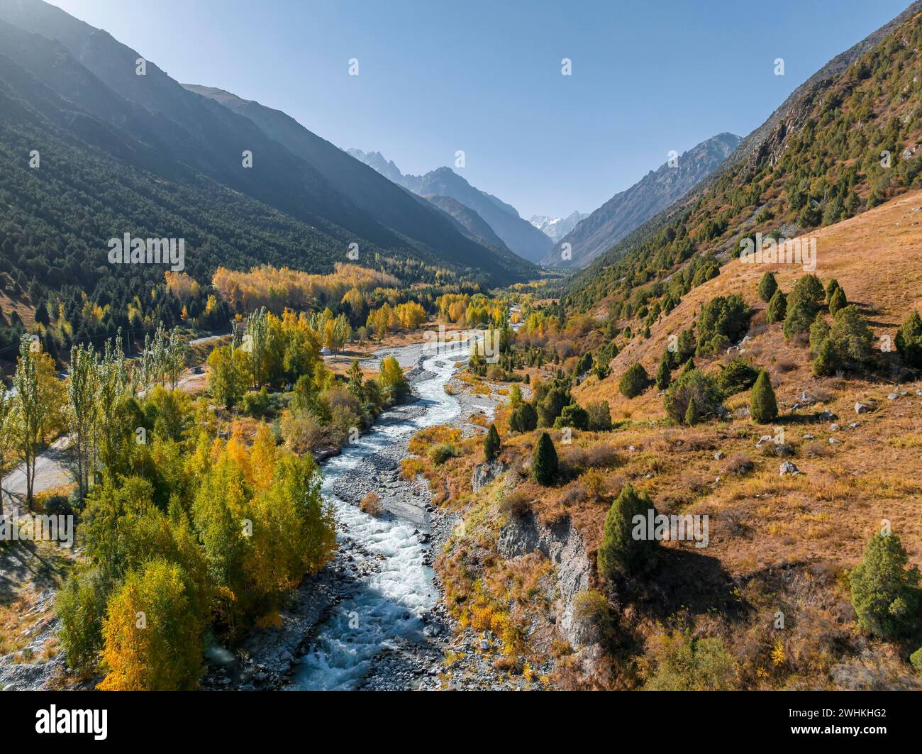 Aerial view, mountain stream Ala Archa flows through the Ala Archa valley, autumnal mountain ...