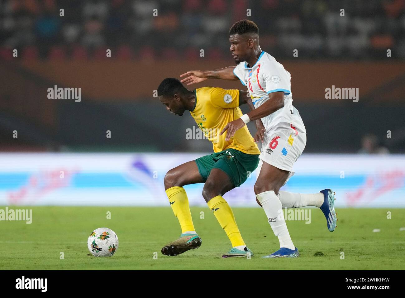 DR Congo's Aaron Tshibola, right, challenges South Africa's Sphephelo ...