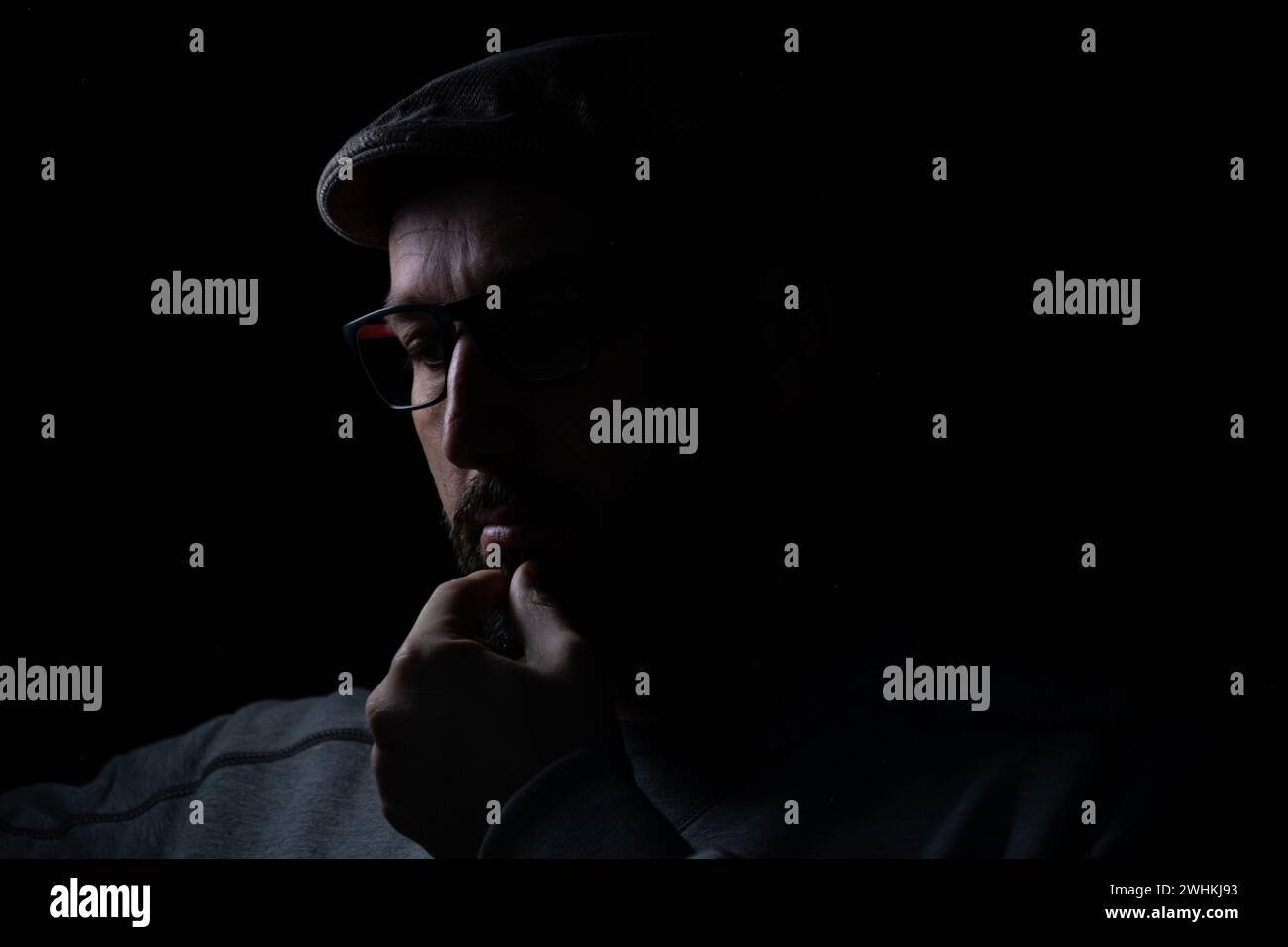 man thinking in dark and light portrait Stock Photo - Alamy