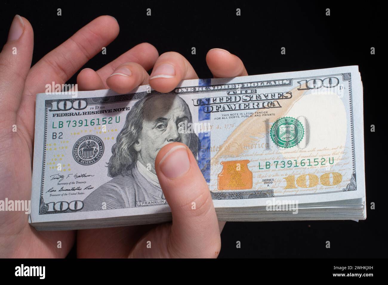 Hand holding American dollar banknotes isolated on white background ...