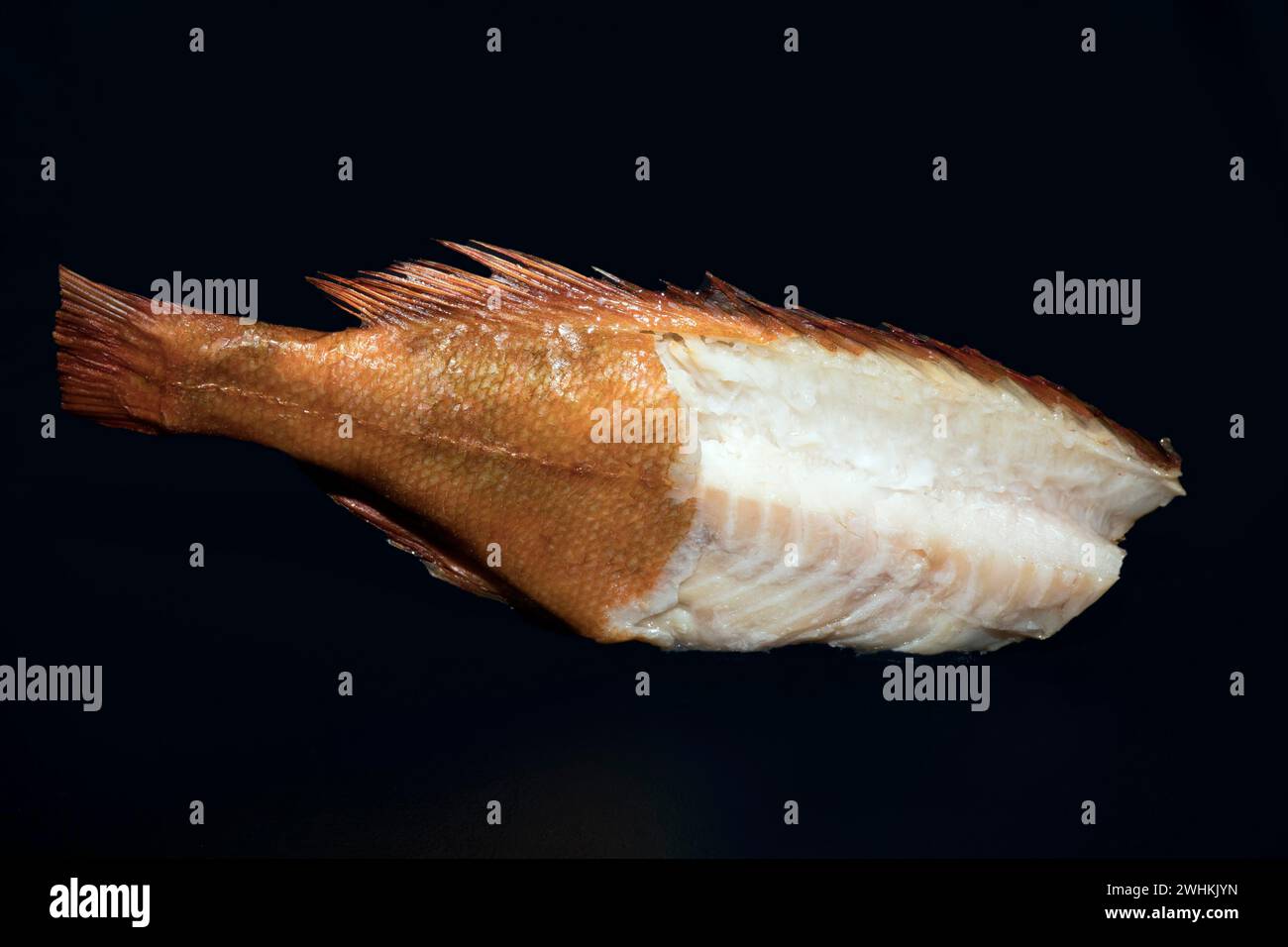 Smoked redfish without head, with half of the skin removed and part of ...