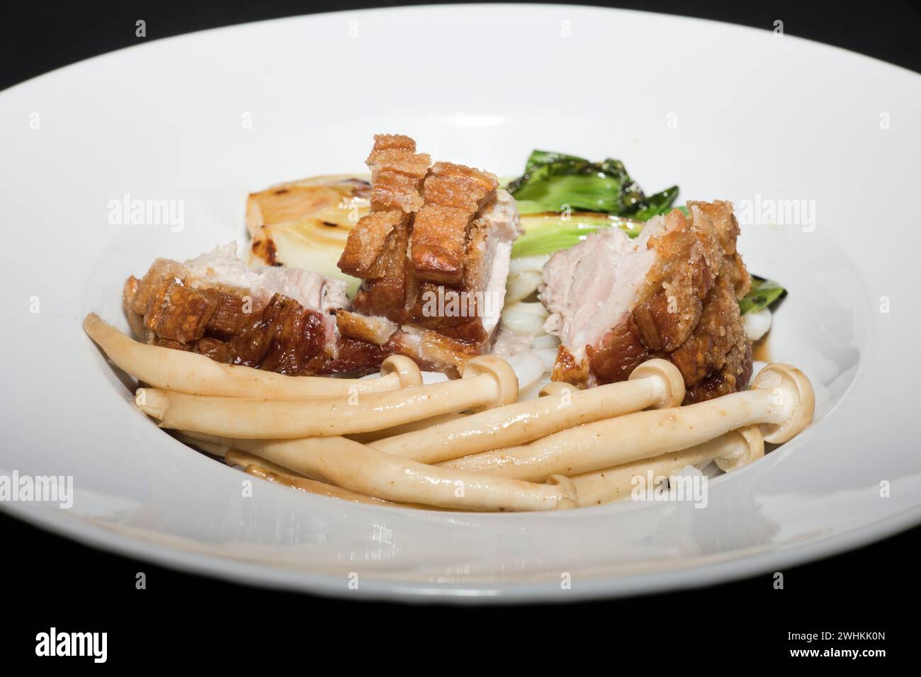 Crispy fried pork belly on Japanese udon noodles, with briefly braised ...