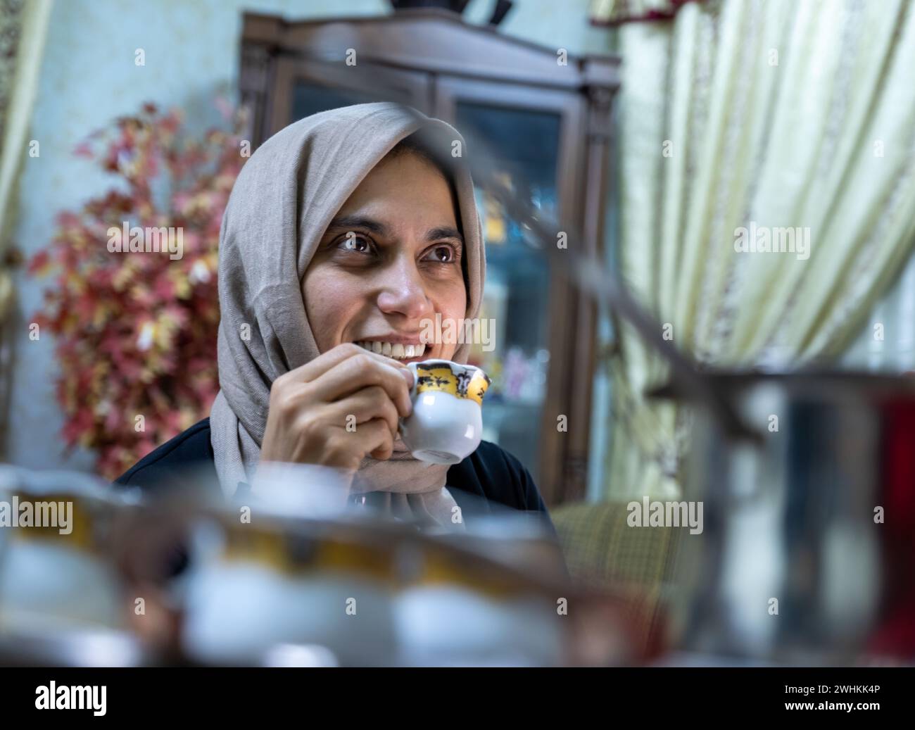 Woman drinking coffee with smilly face Stock Photo - Alamy