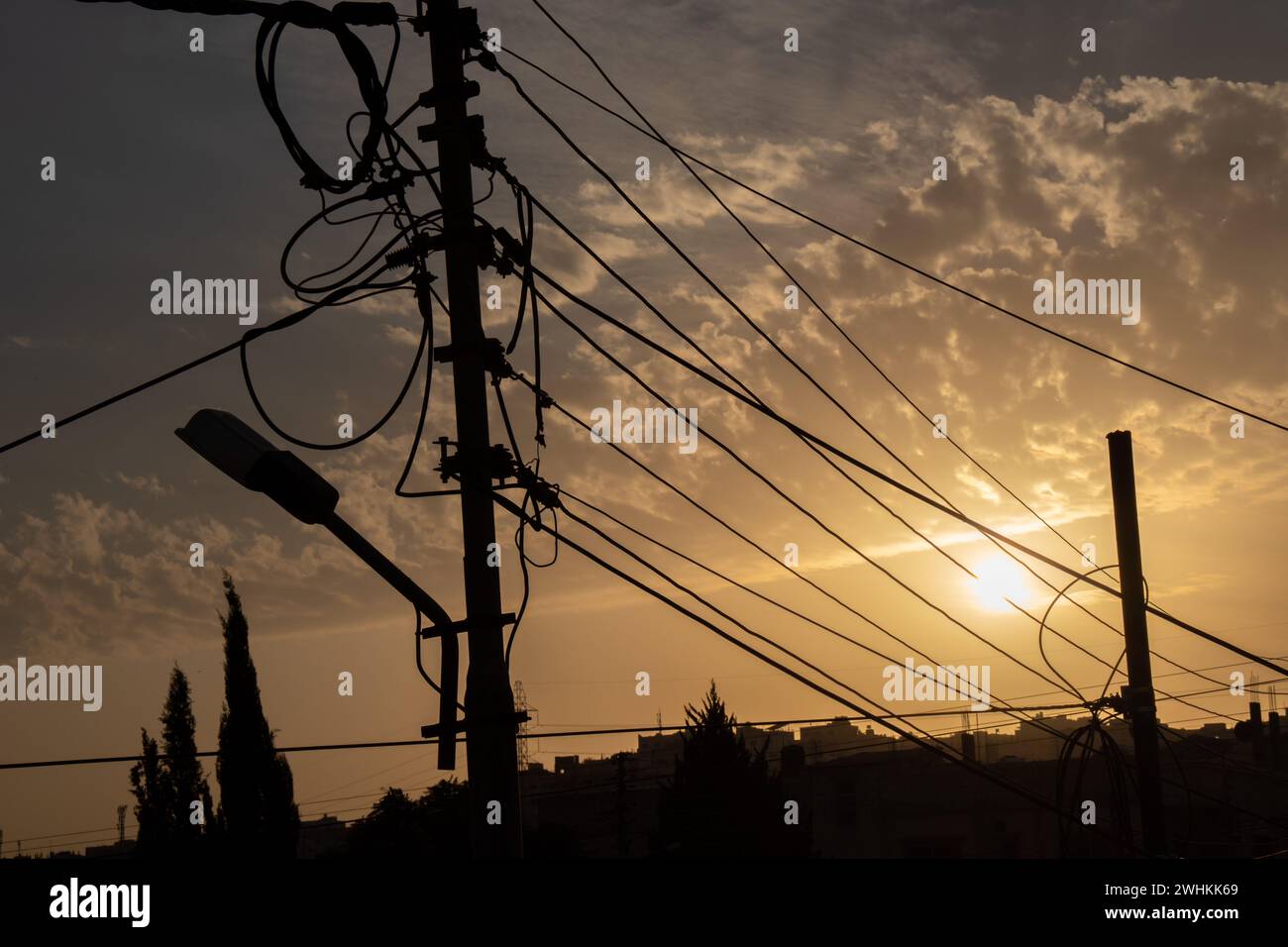 silhouette of electrical lines, fiber cables node and light at the ...
