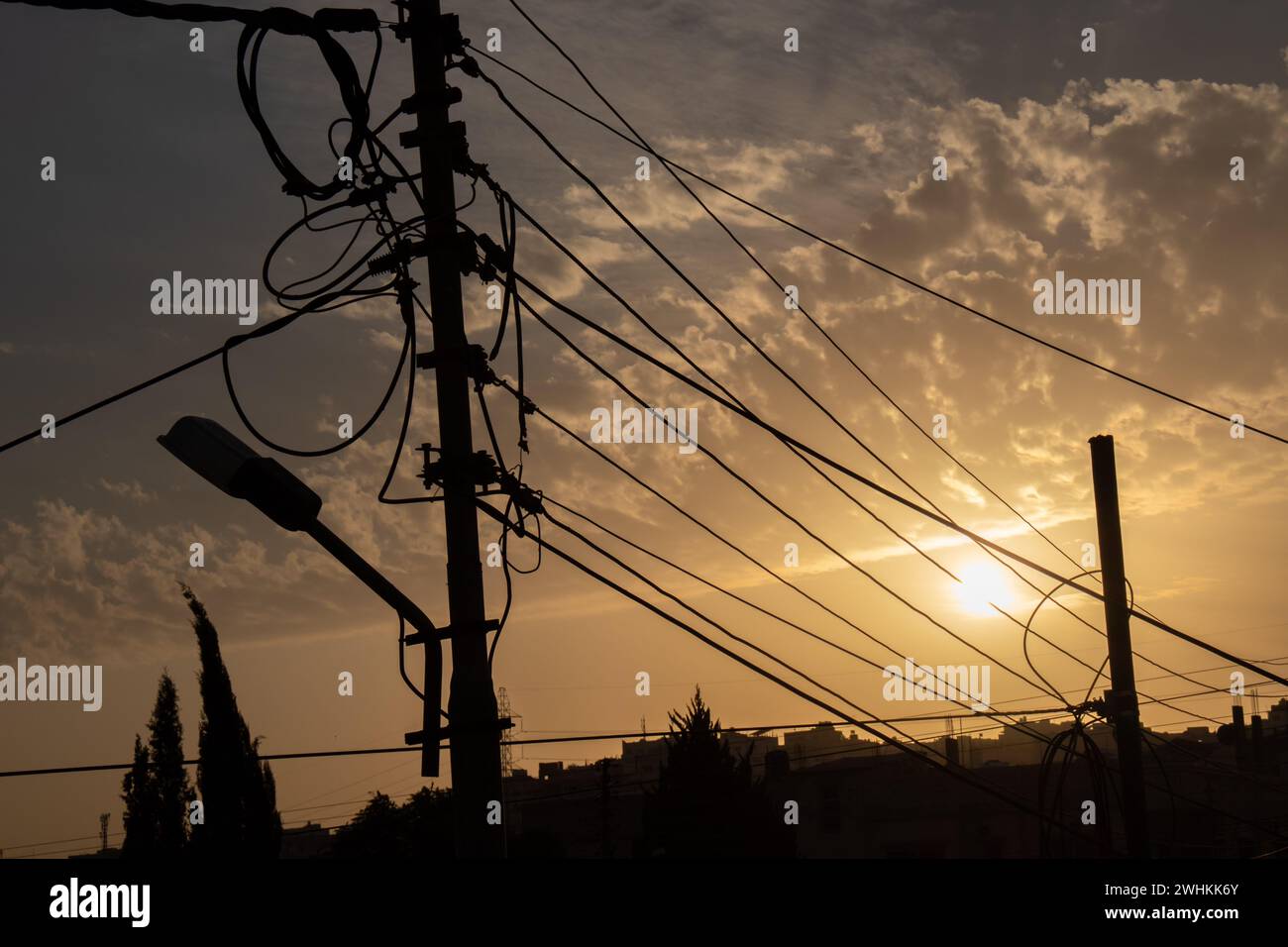silhouette of electrical lines, fiber cables node and light at the ...