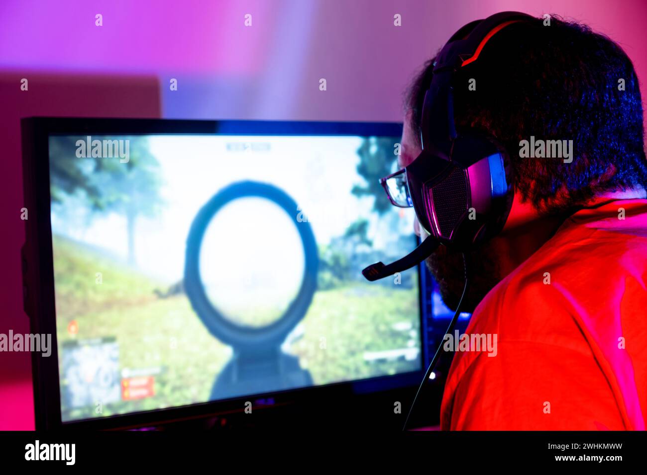 Guy streaming while playing shooting game Stock Photo - Alamy